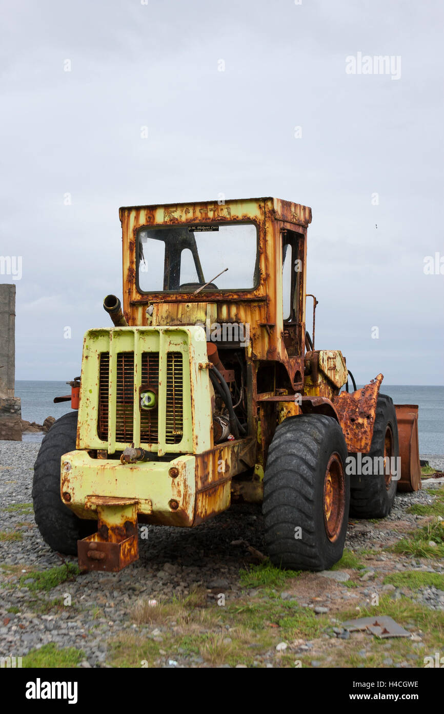 Rusty digger on beach Stock Photo - Alamy
