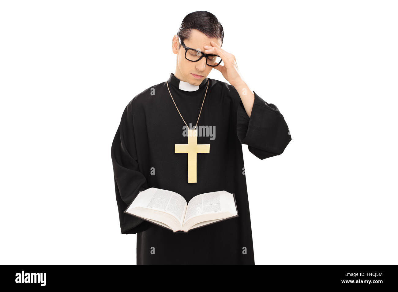 Sad young priest reading the bible isolated on white background Stock ...
