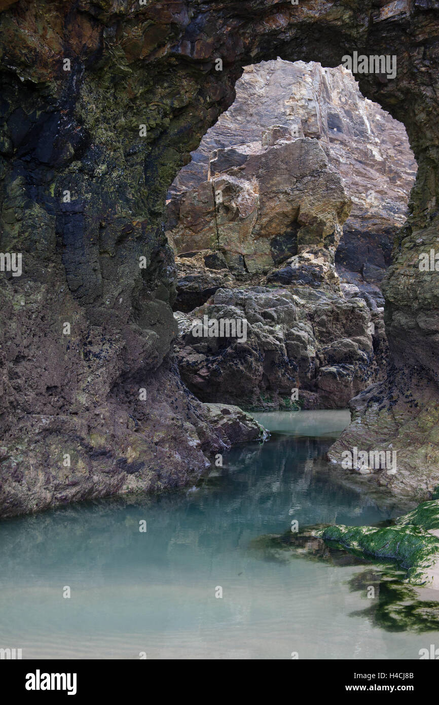 Sea arch at Perranporth at low tide. Sea arch and rock pool on the ...