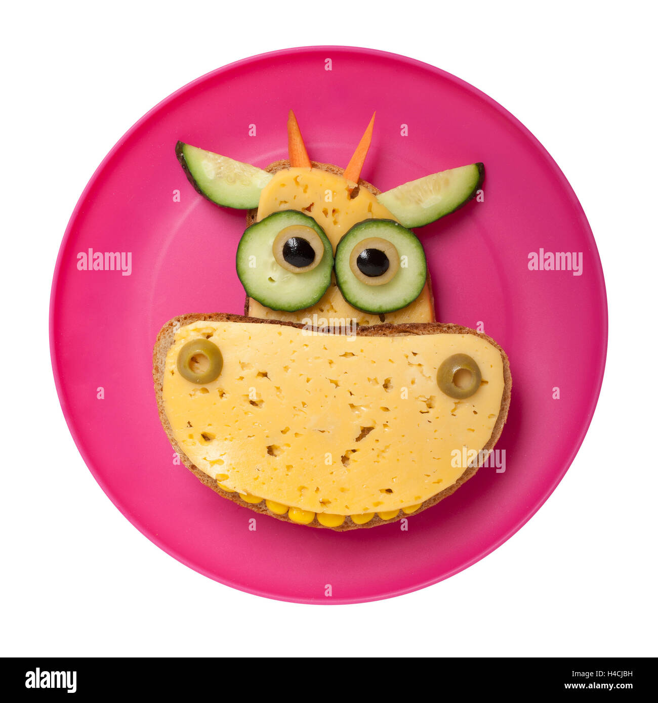 Cow made of bread and cheese on plate Stock Photo - Alamy