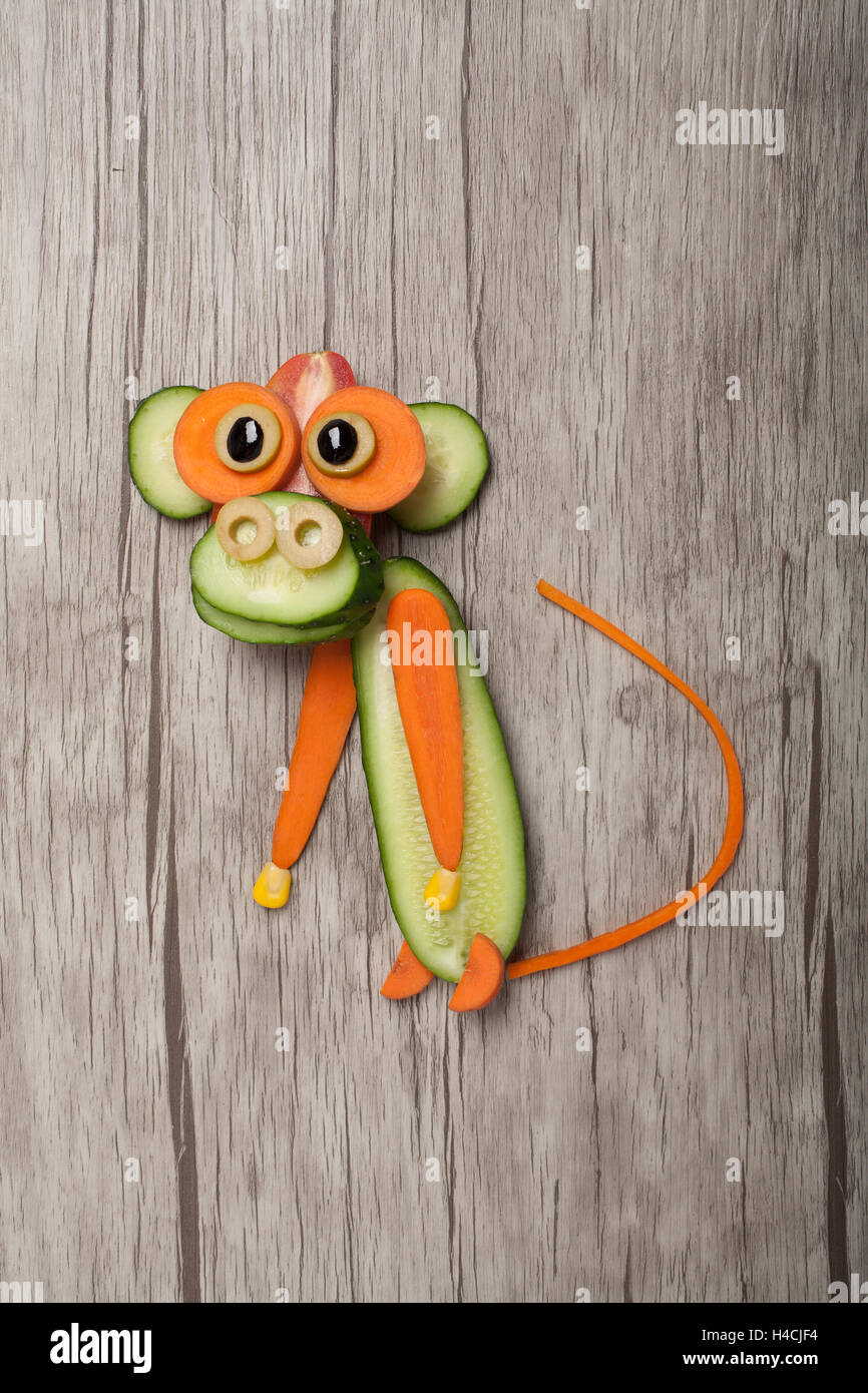 Funny monkey made of cucumber and carrot on board Stock Photo - Alamy