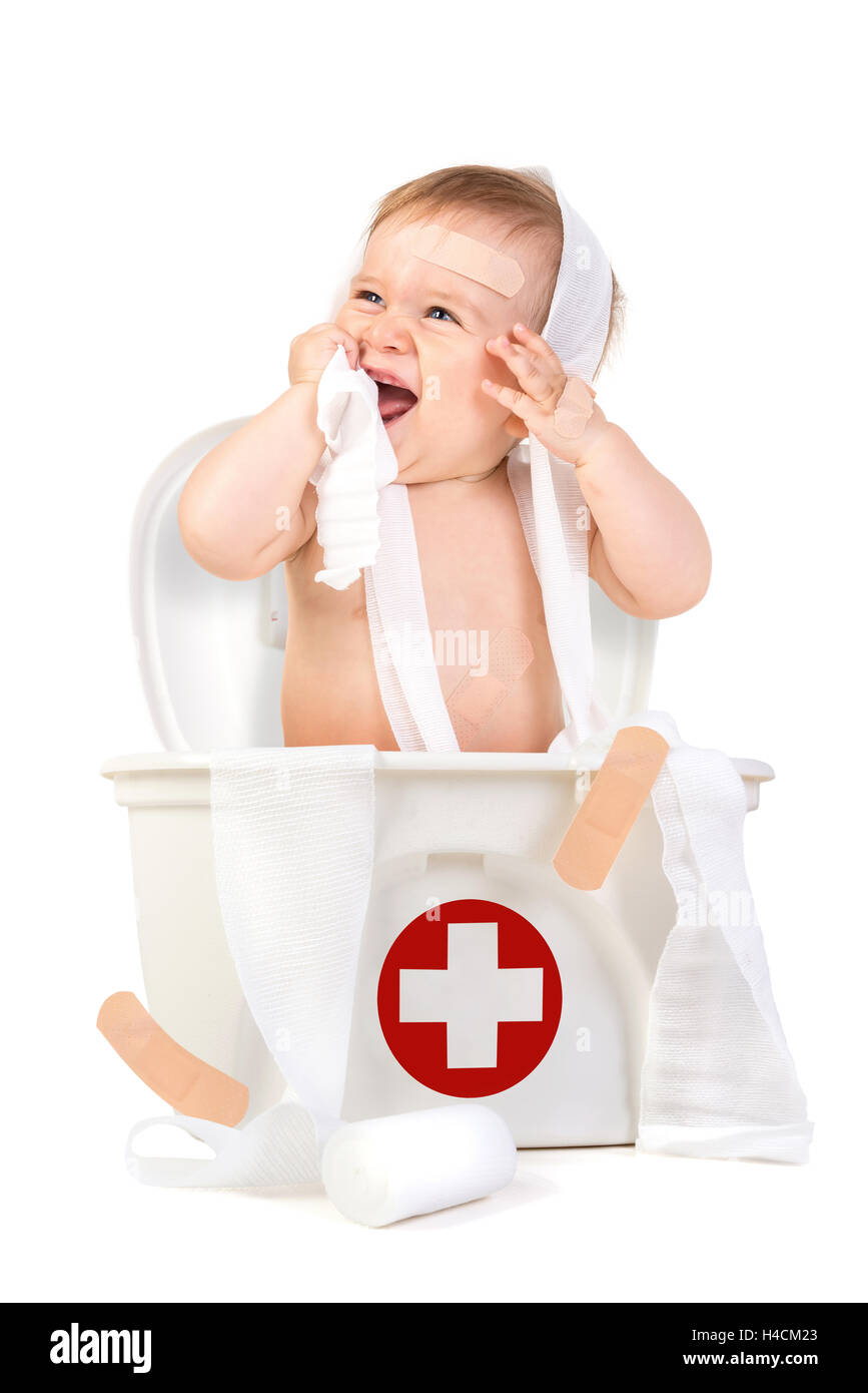 Cute baby boy playing with bandages in a first aid kit box Stock Photo ...
