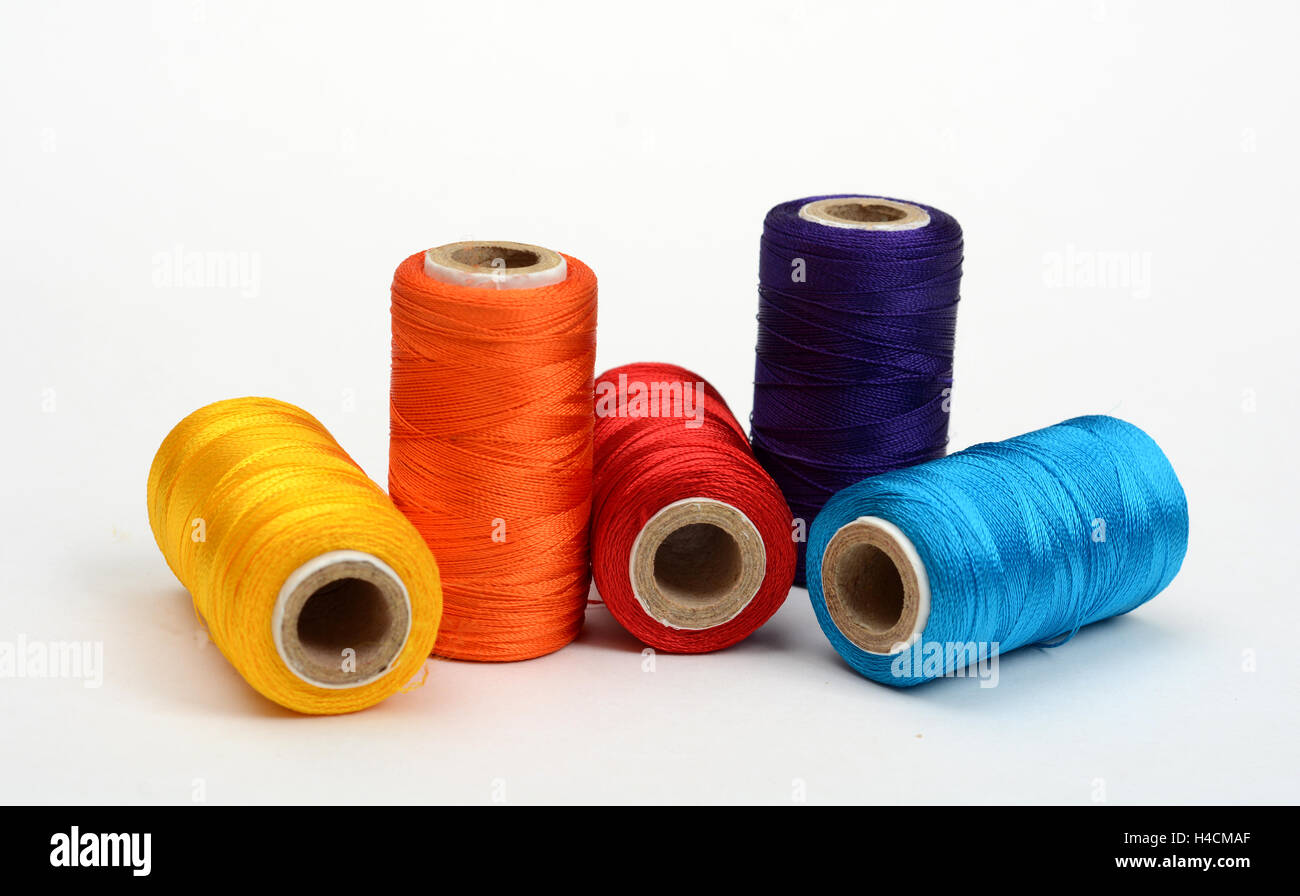 Spools of colorful silk threads on white background Stock Photo - Alamy