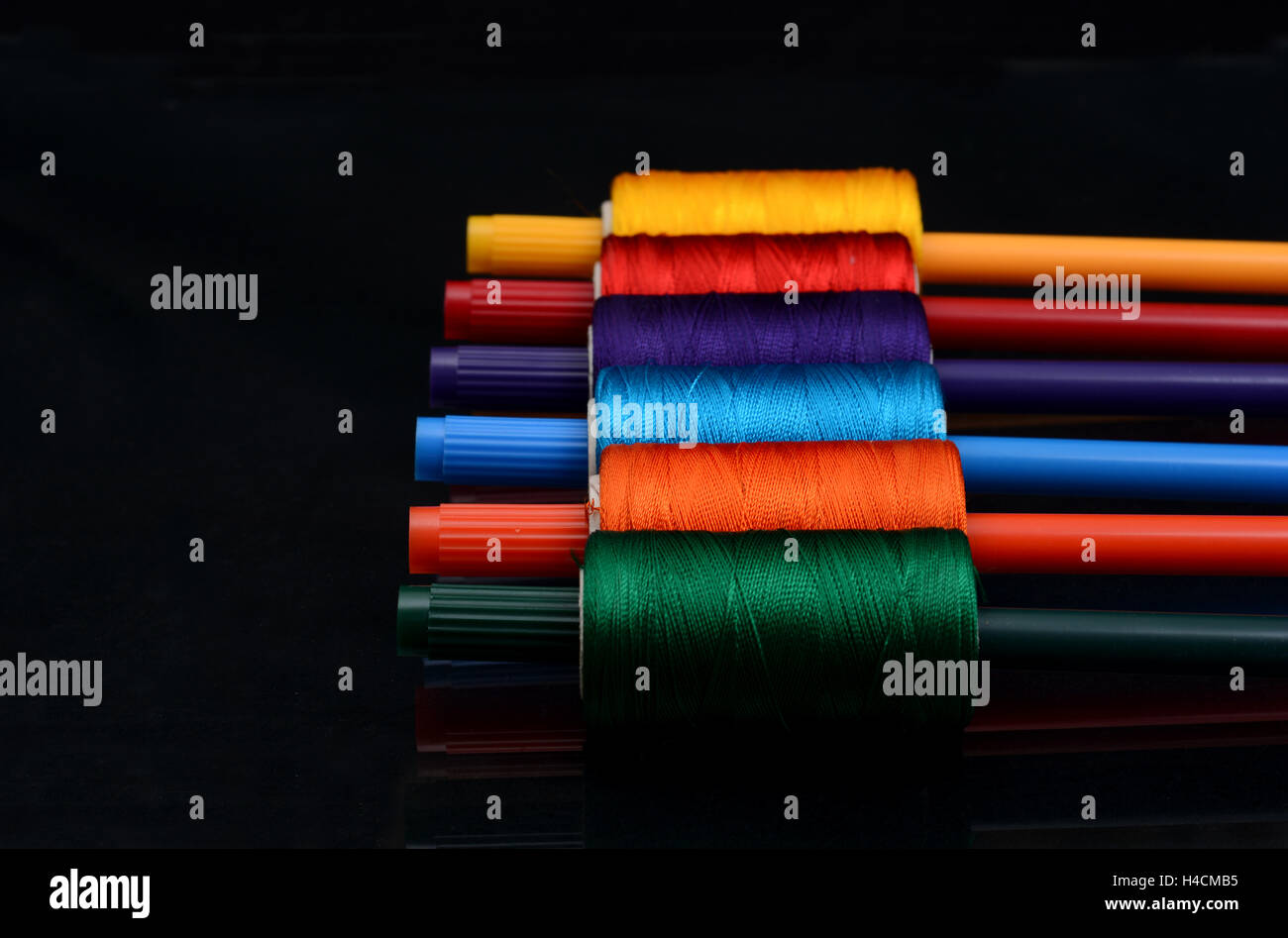 Set of Colorful silk threads on black with marker Stock Photo - Alamy