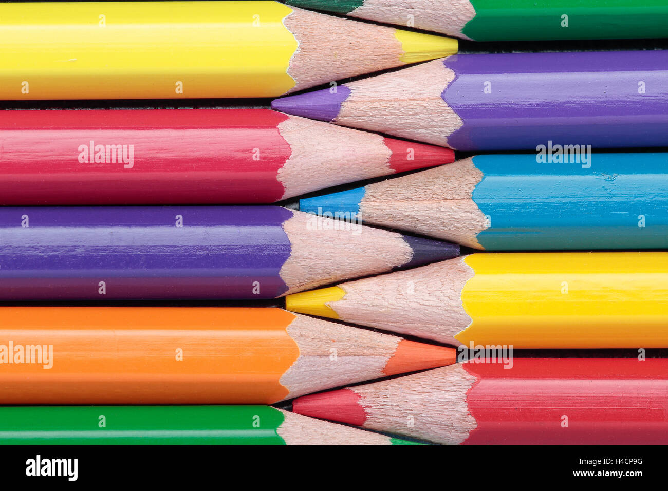 foreground of some crayons interleaved on a horizontal composition ...