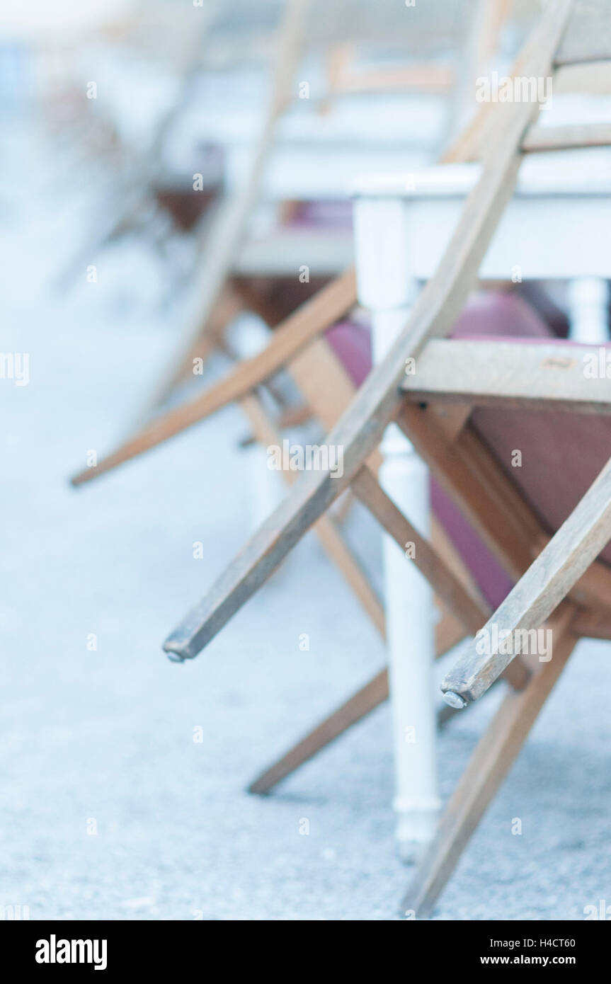 Tables and wooden chairs in of a row Stock Photo - Alamy