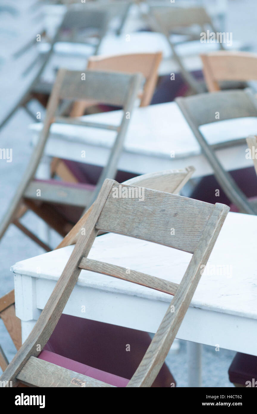 Tables and wooden chairs in of a row Stock Photo - Alamy