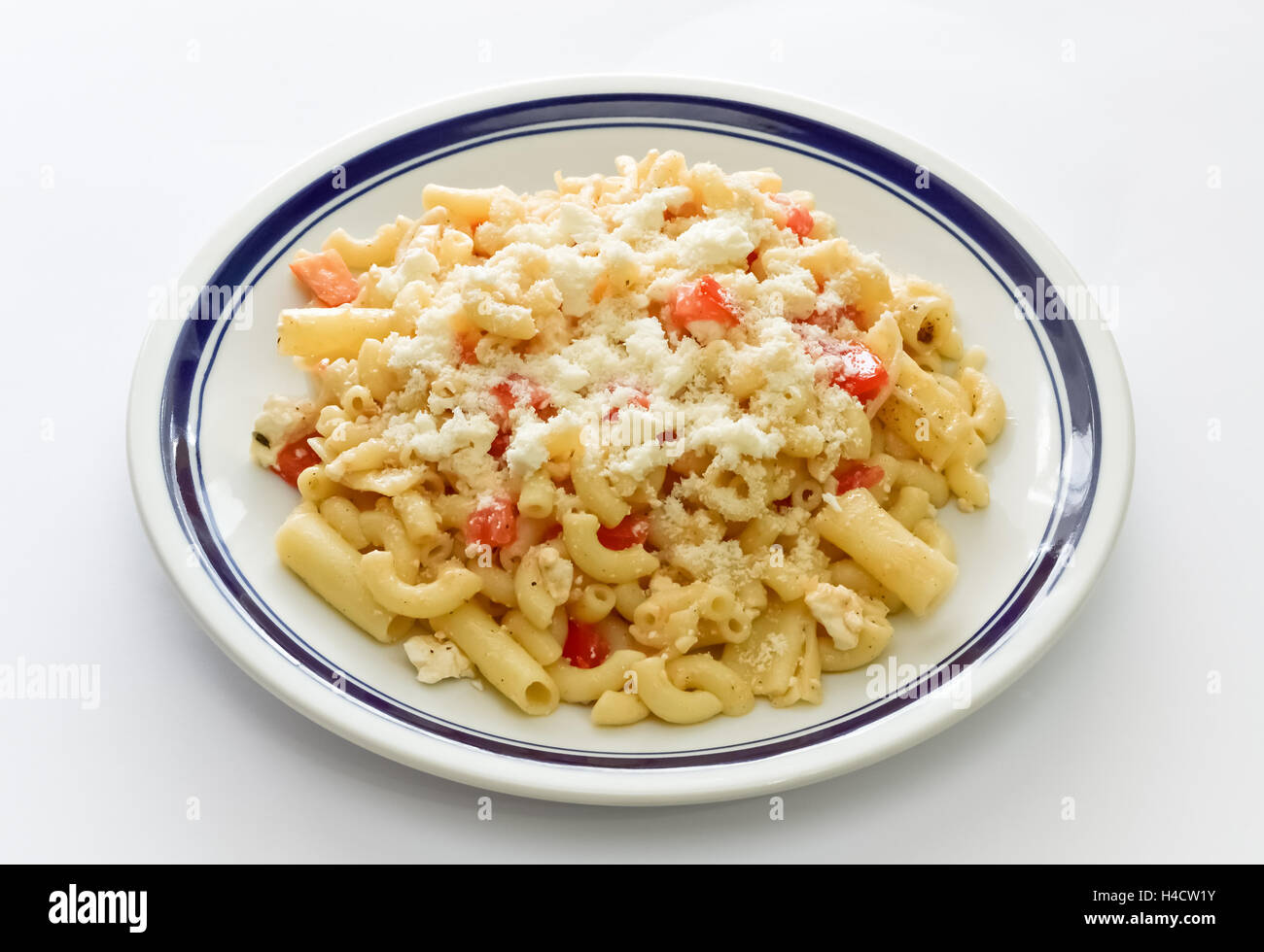 Boiled macaroni with tomatoes and parmesan served in plate Stock Photo ...