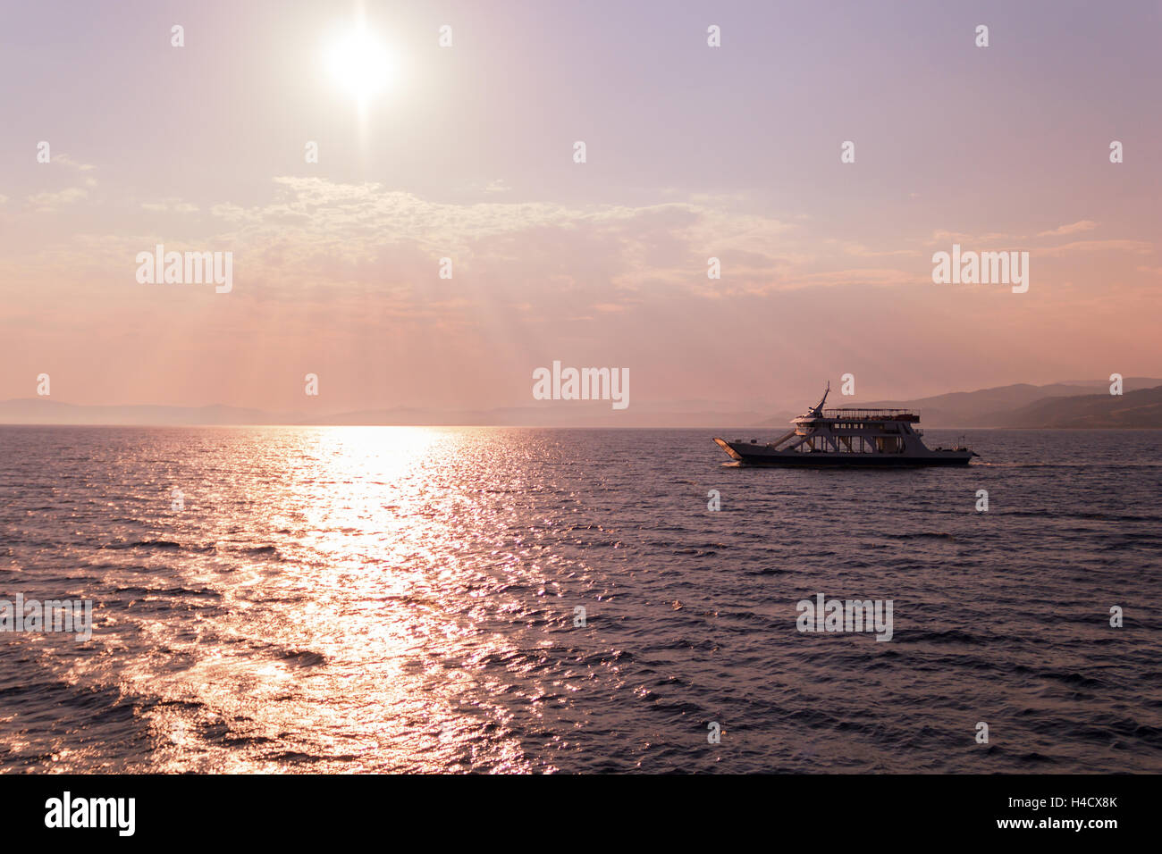 beautiful sunset and a boat on the beach Stock Photo - Alamy