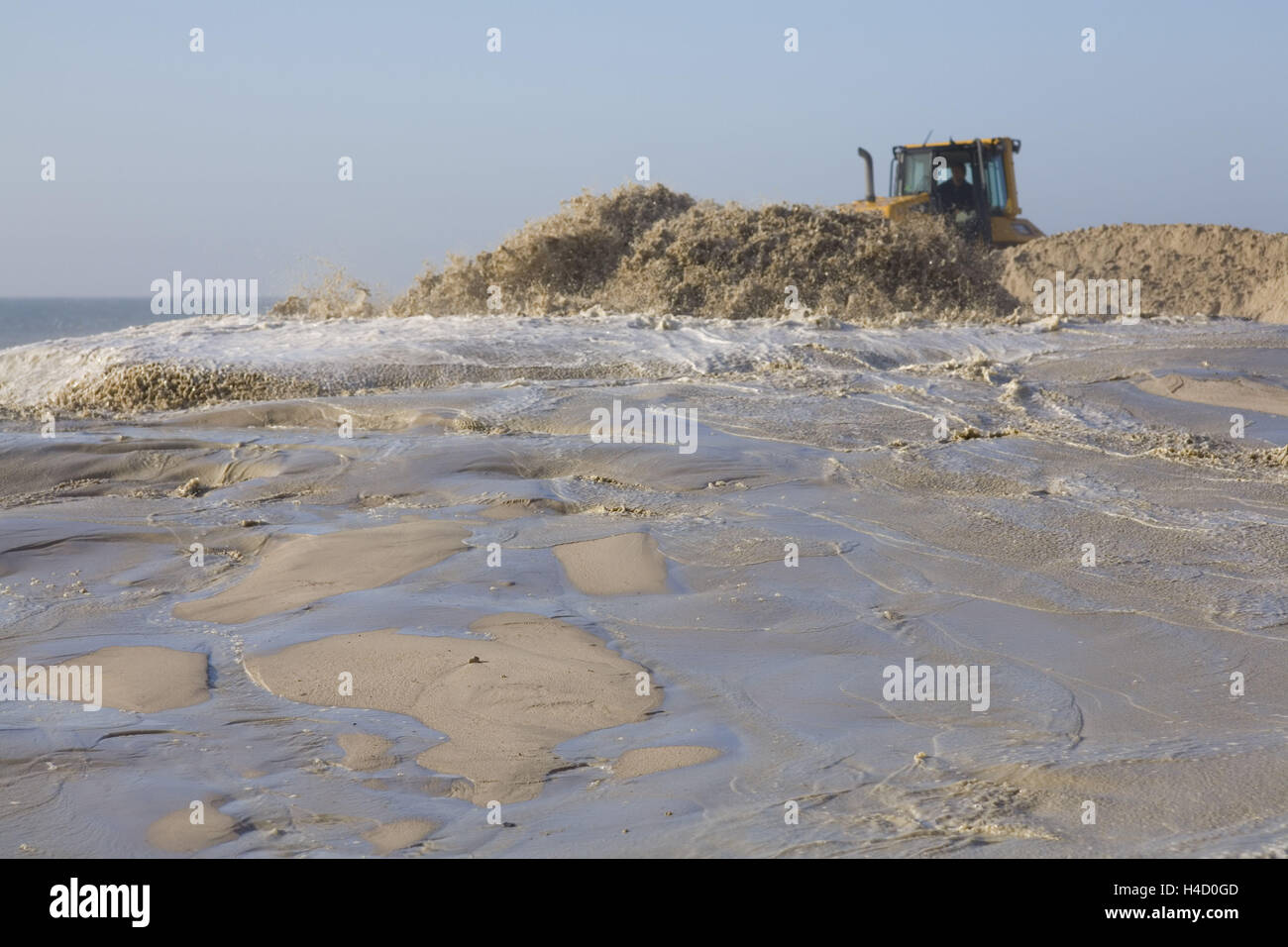 Sand replenishment at the red cliff Stock Photo - Alamy