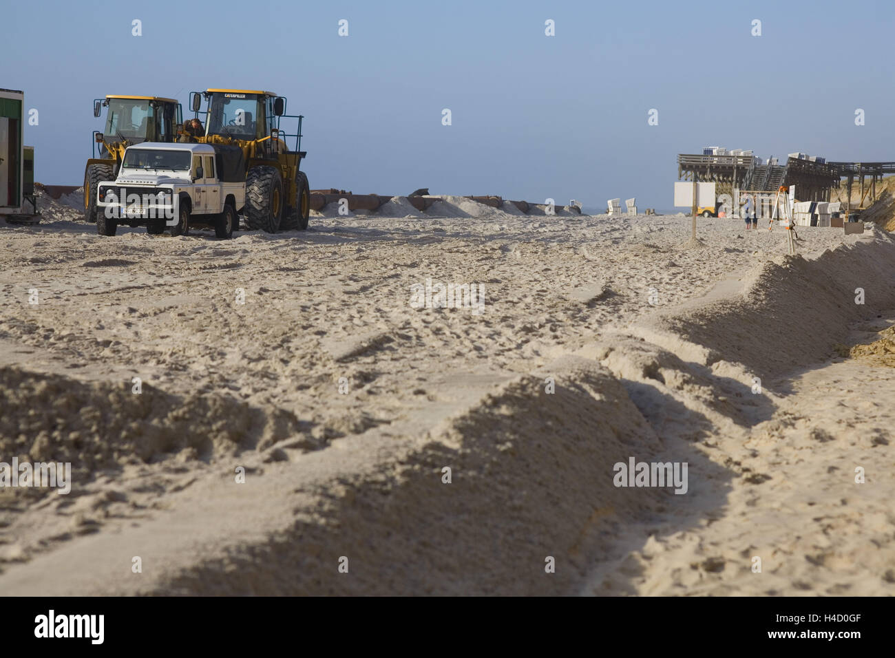Sand replenishment at the red cliff Stock Photo - Alamy