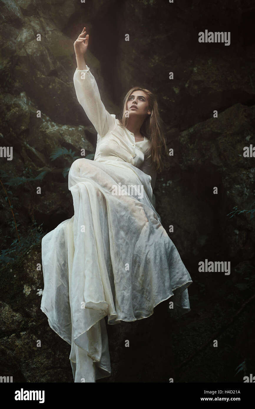 Woman posing on forest rocks. Dreamy atmosphere Stock Photo - Alamy