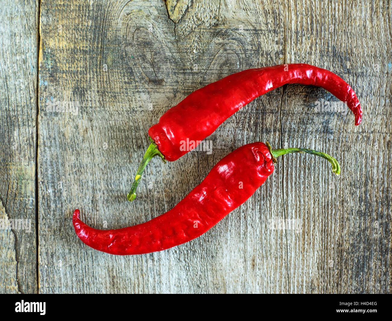 Red hot chili pepper on old wooden weathering table Stock Photo - Alamy