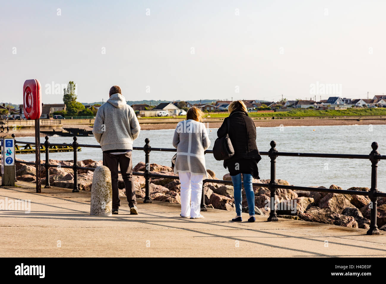 Three visitors look from Hampton pier towards Whitstable, Herne Bay ...