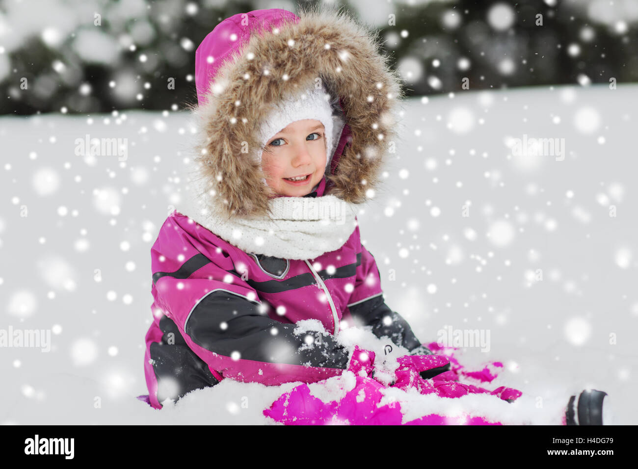 happy kid in winter clothes playing with snow Stock Photo - Alamy