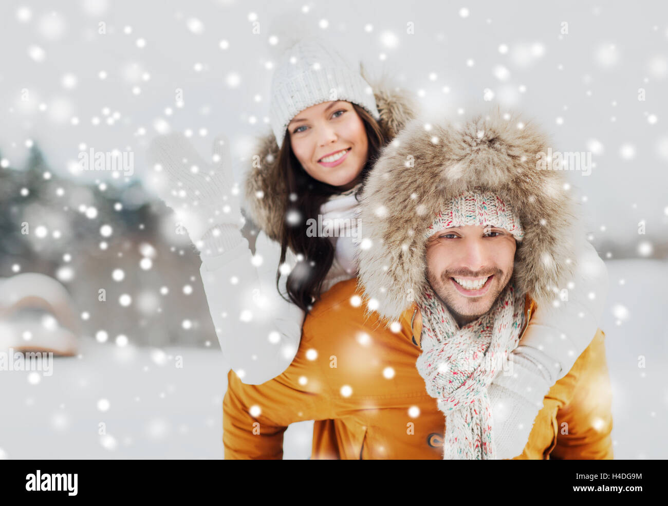 happy couple having fun over winter background Stock Photo - Alamy