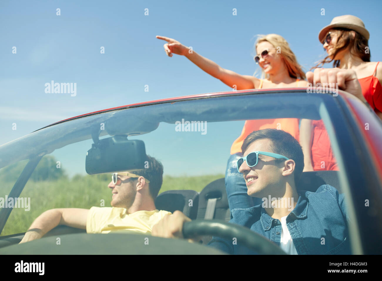 happy friends driving in cabriolet car at country Stock Photo - Alamy