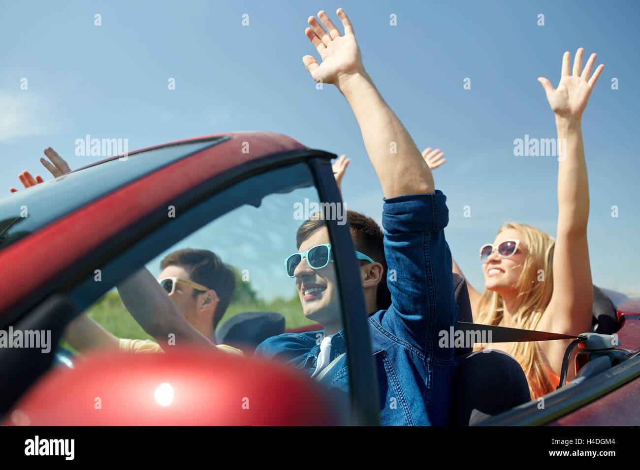 happy friends driving in cabriolet car at country Stock Photo - Alamy