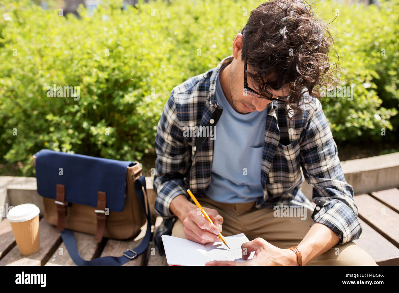 man with notebook or diary writing on city street Stock Photo - Alamy