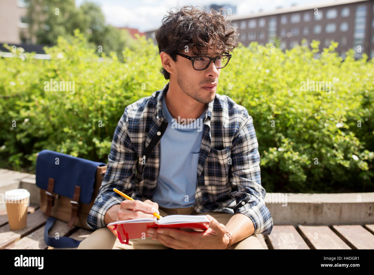 man with notebook or diary writing on city street Stock Photo - Alamy