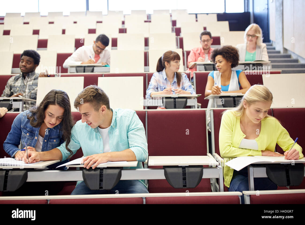 group of students with notebooks at lecture hall Stock Photo - Alamy