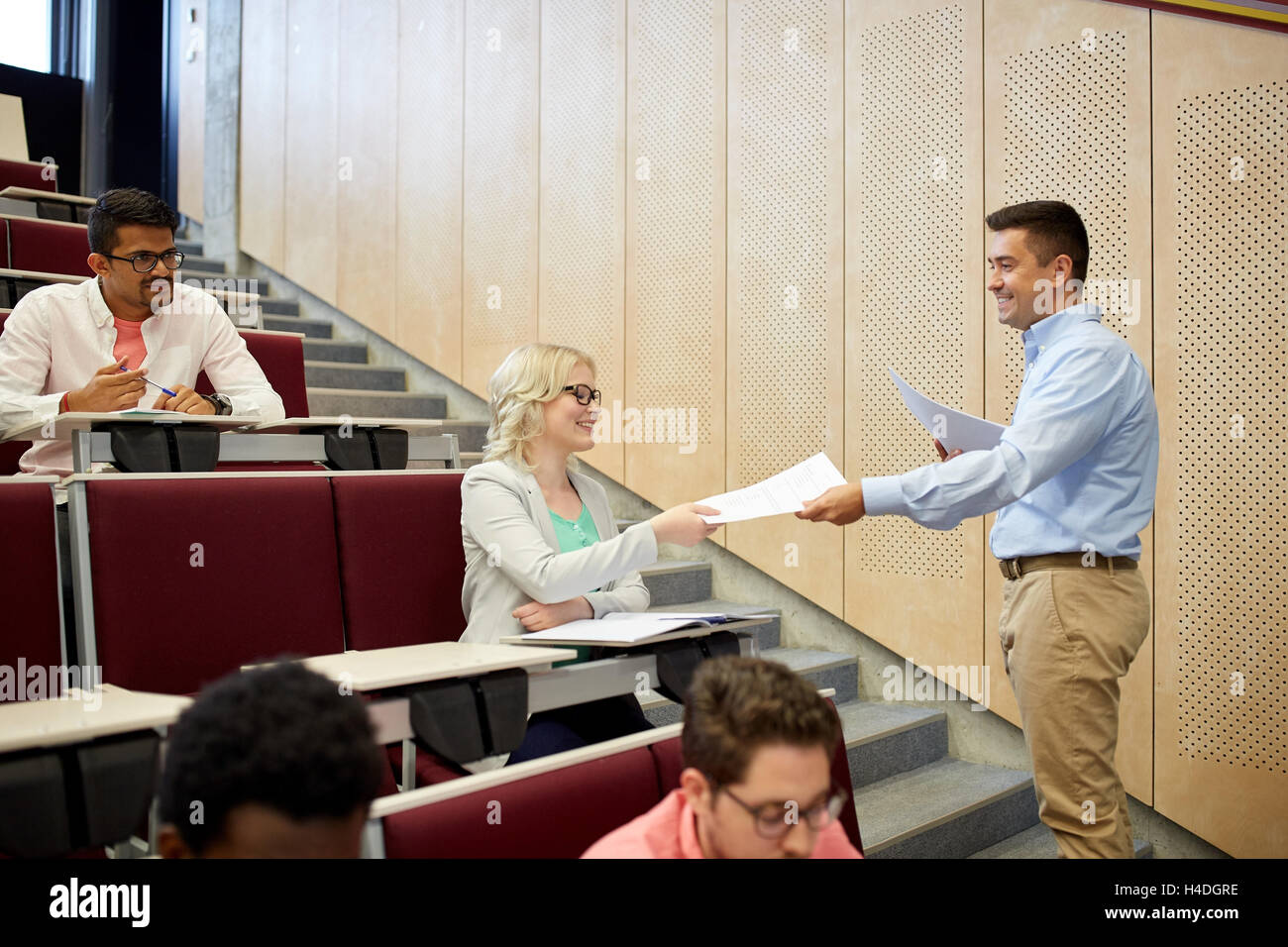 teacher giving tests to students at lecture Stock Photo - Alamy