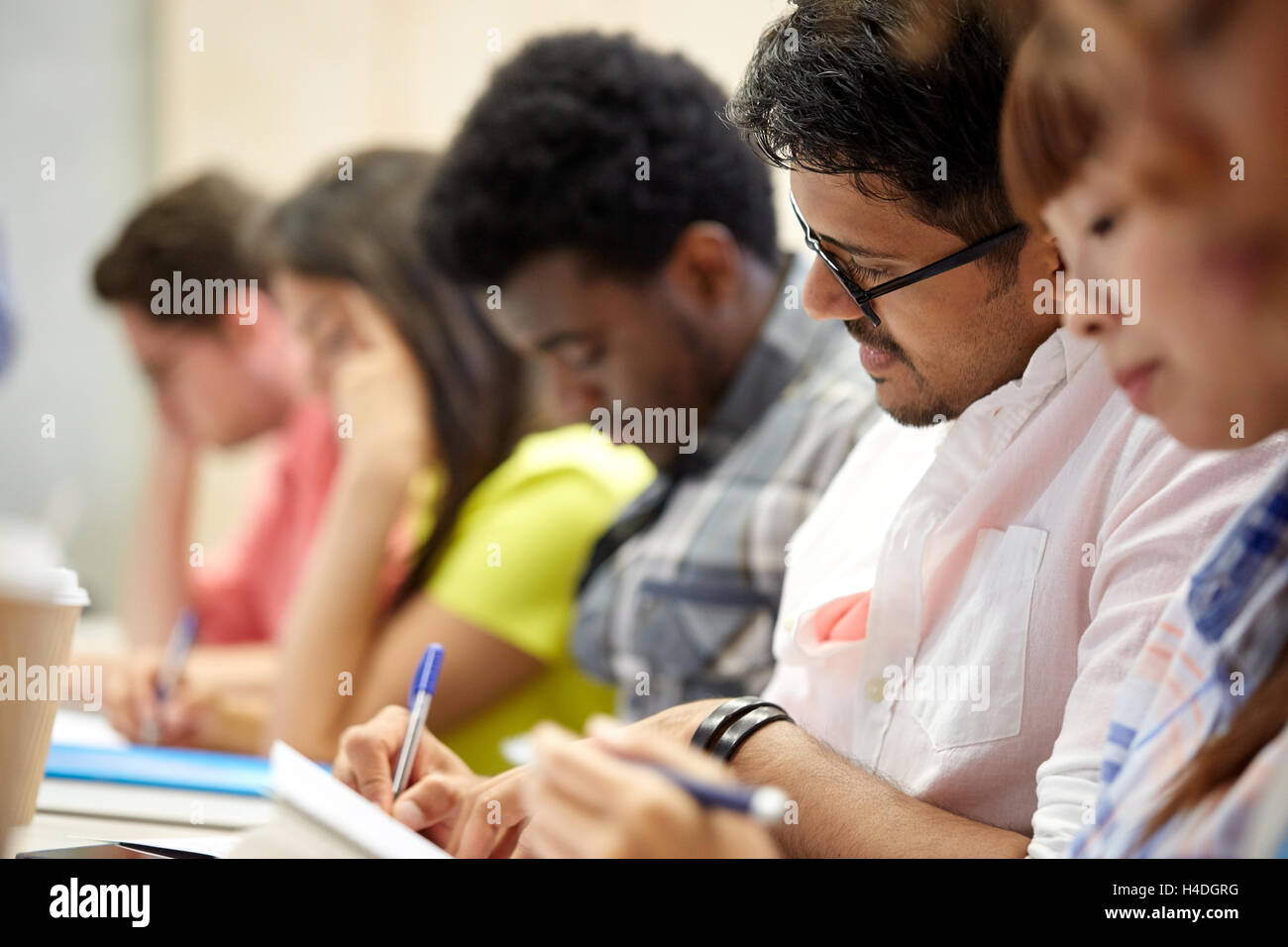 group of international students writing at lecture Stock Photo - Alamy