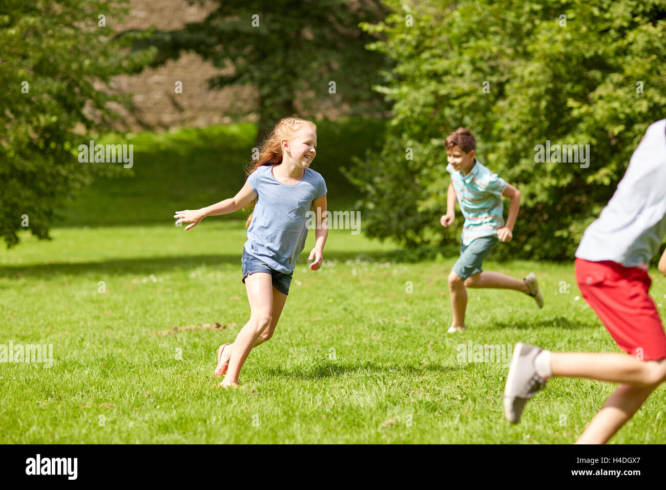 happy kids running and playing game outdoors Stock Photo - Alamy