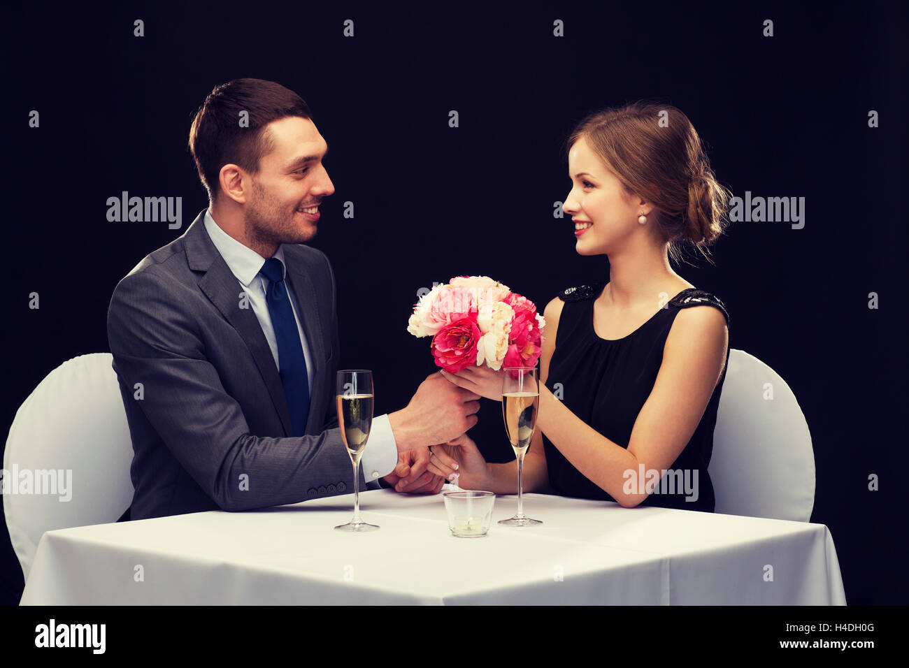 smiling man giving flower bouquet to woman Stock Photo - Alamy