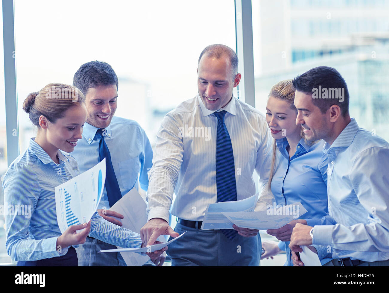 business people with papers talking in office Stock Photo - Alamy