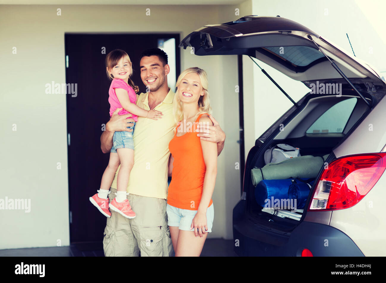 happy family with hatchback car at home parking Stock Photo - Alamy