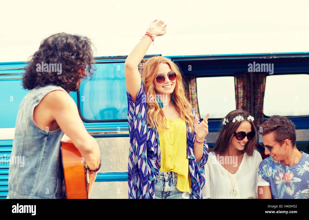 happy hippie friends having fun over minivan car Stock Photo - Alamy