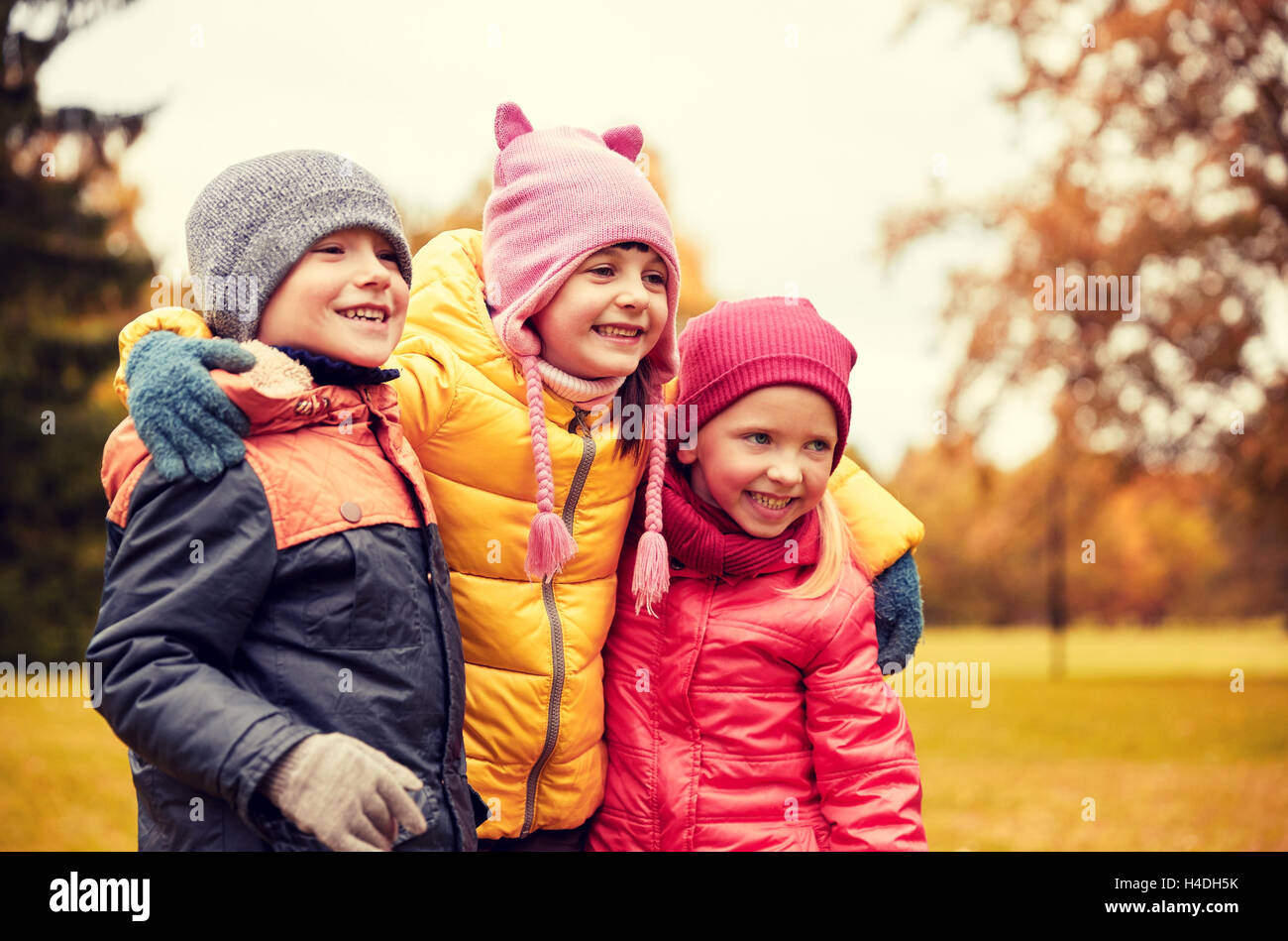 group of happy children hugging in autumn park Stock Photo - Alamy