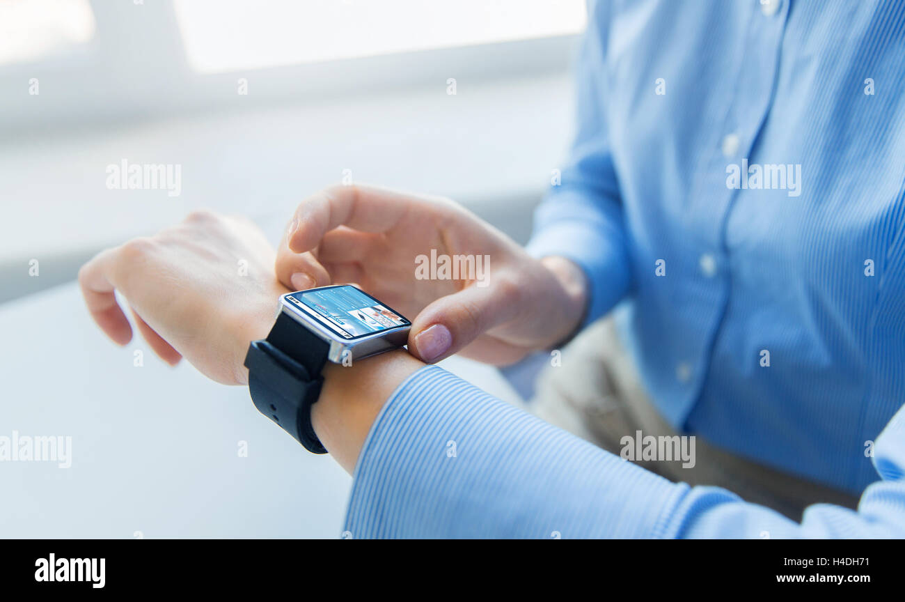 close up of hands with business news on smartwatch Stock Photo - Alamy