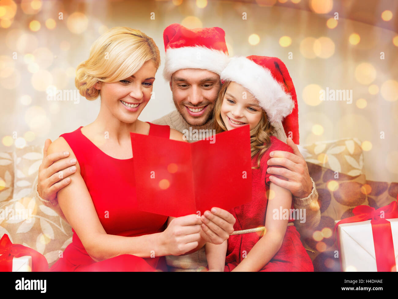 smiling family reading postcard Stock Photo - Alamy