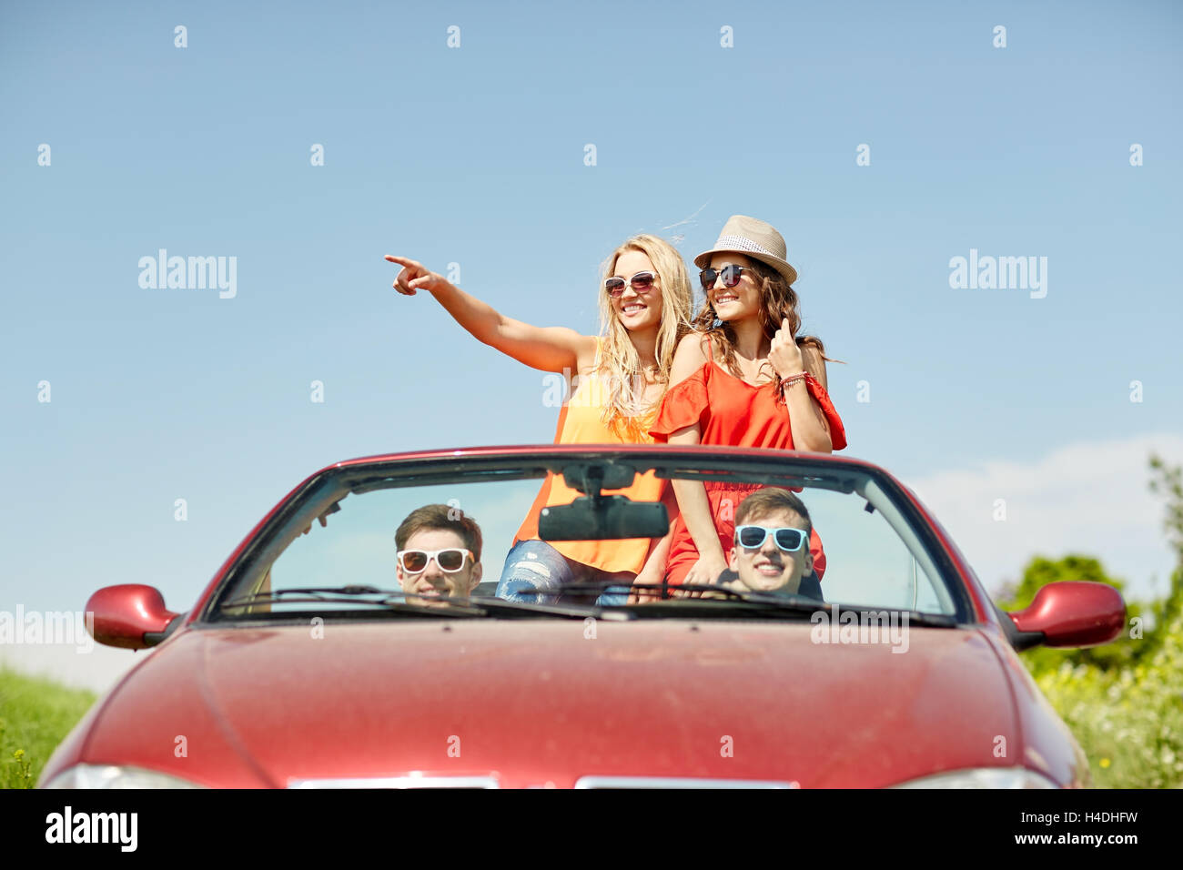 happy friends driving in cabriolet car at country Stock Photo - Alamy