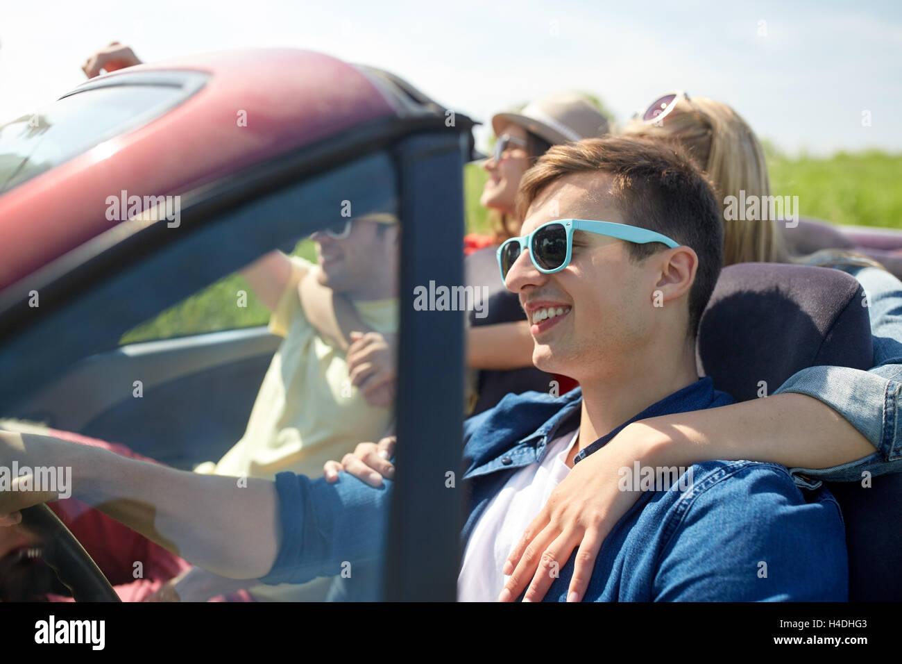 happy friends driving in cabriolet car at country Stock Photo - Alamy