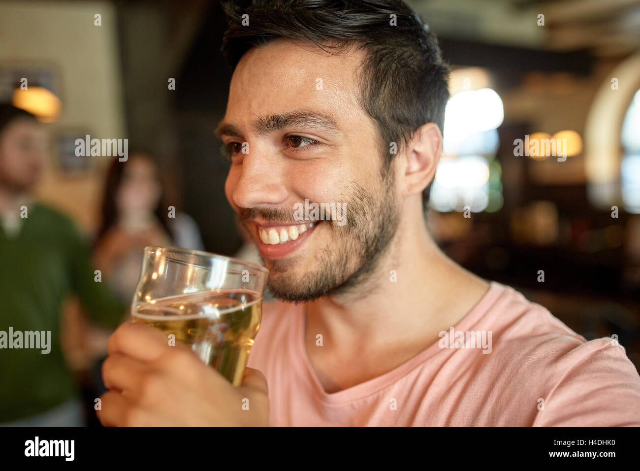 close up of happy man drinking beer at bar or pub Stock Photo - Alamy