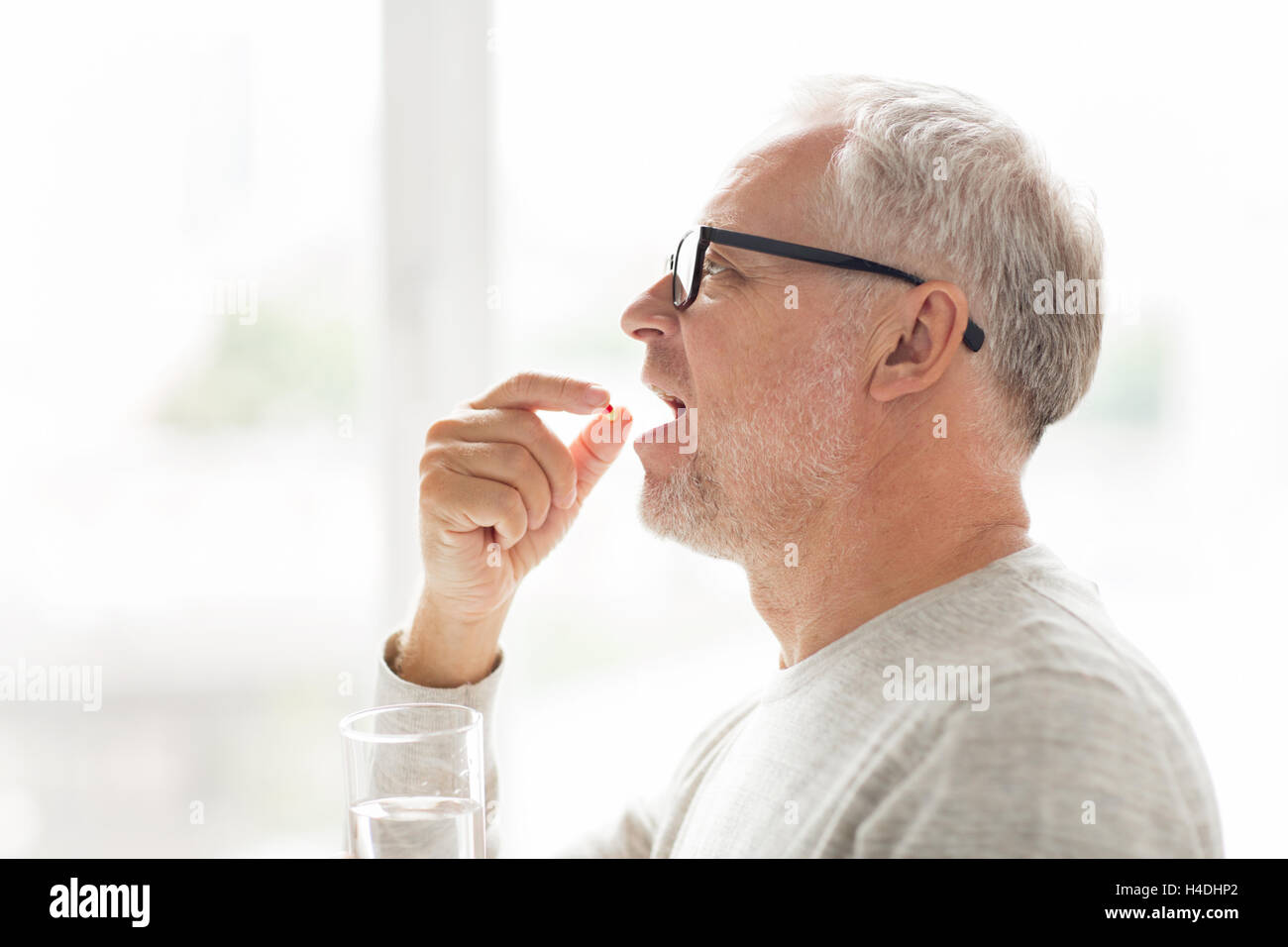 Man home taking medicine hi-res stock photography and images - Alamy