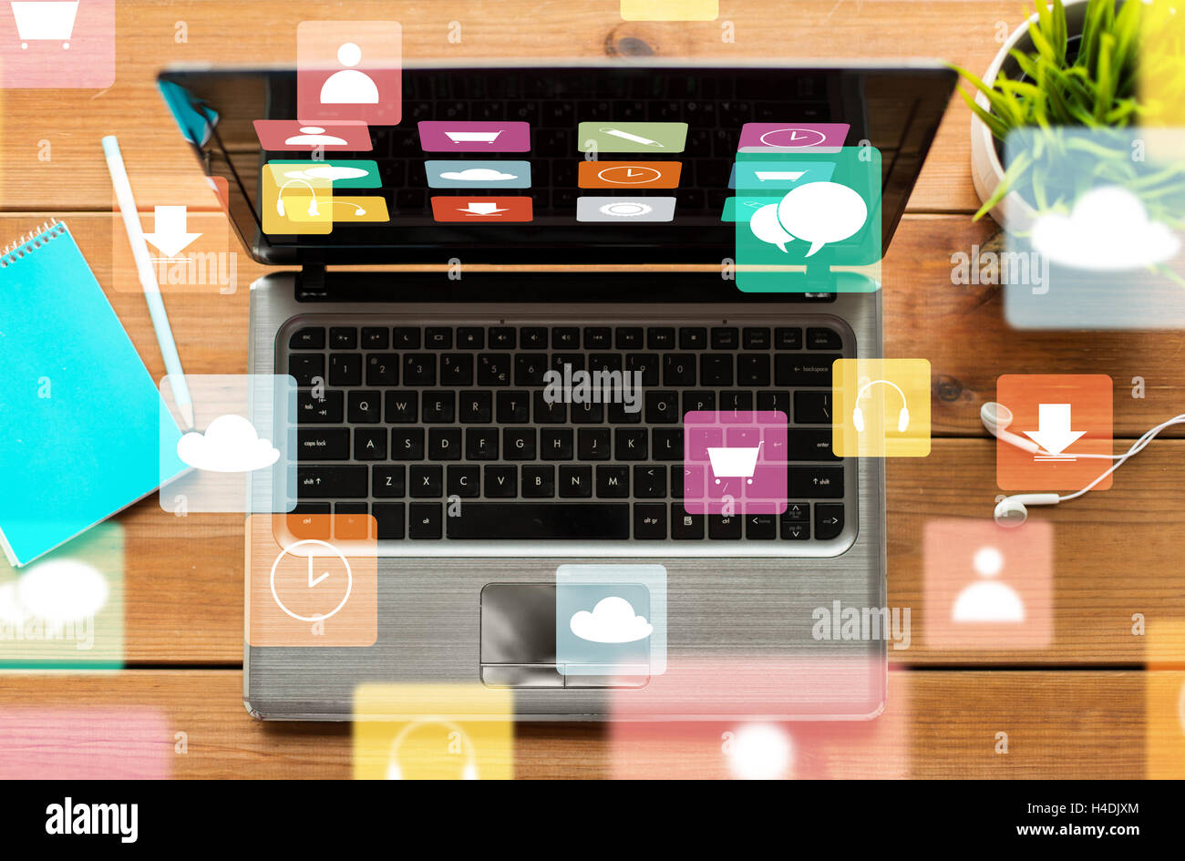 close up of laptop on wooden table with menu icons Stock Photo - Alamy