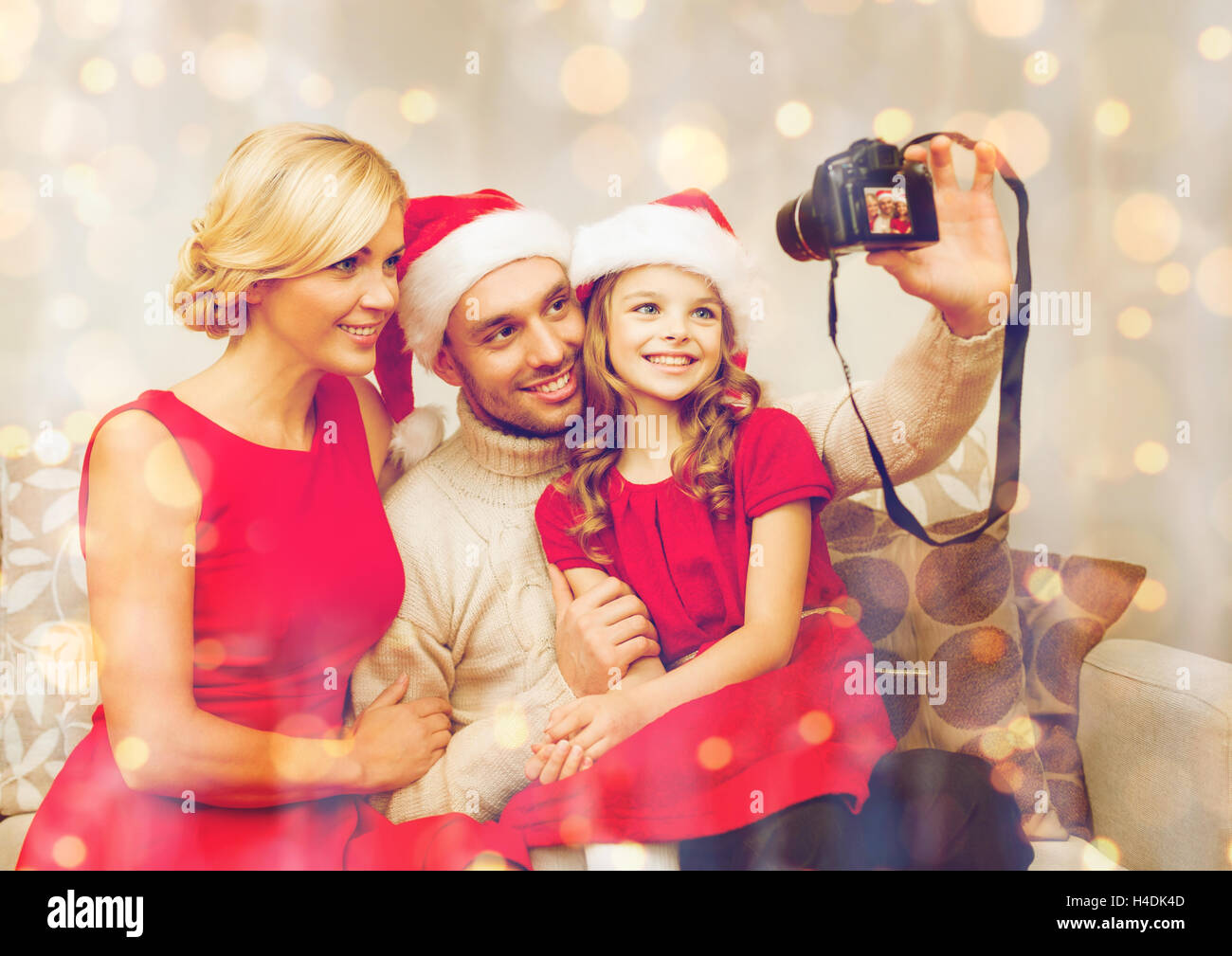 smiling family in santa helper hats taking picture Stock Photo - Alamy