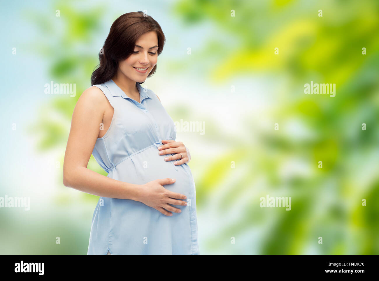 happy pregnant woman touching her big belly Stock Photo - Alamy
