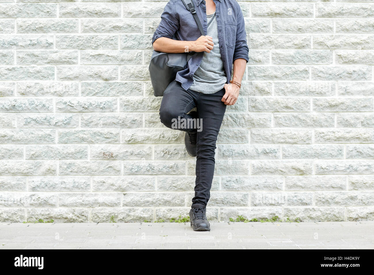 close up of man with backpack standing at wall Stock Photo - Alamy