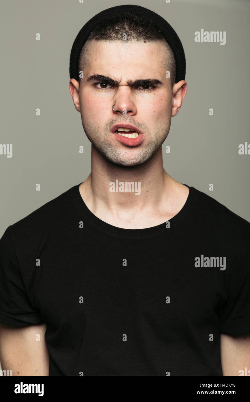 Studio portrait of provocative angry man Stock Photo - Alamy
