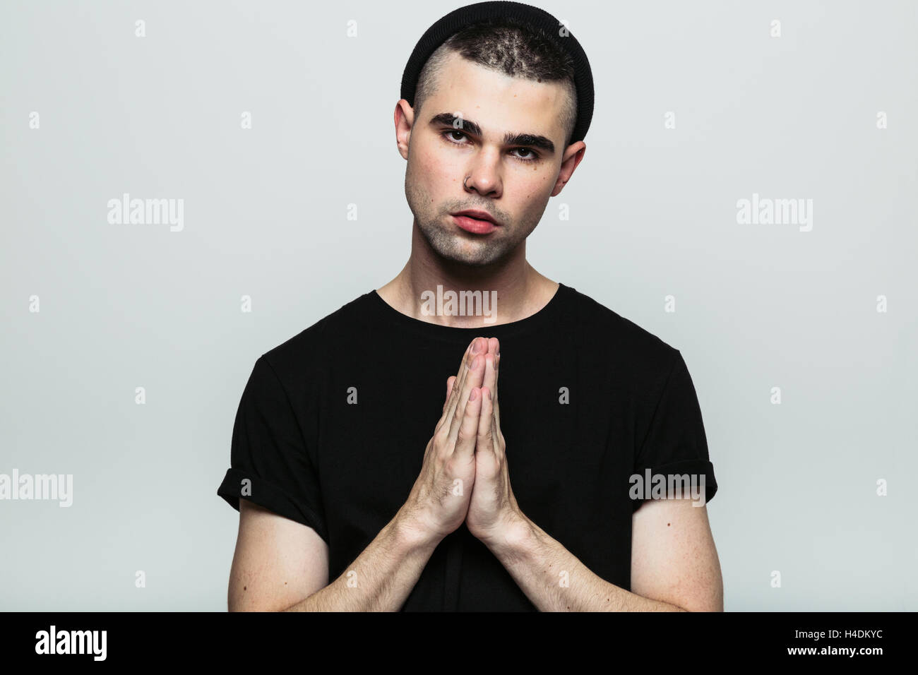 Portrait of man apologizes and looking at camera Stock Photo - Alamy