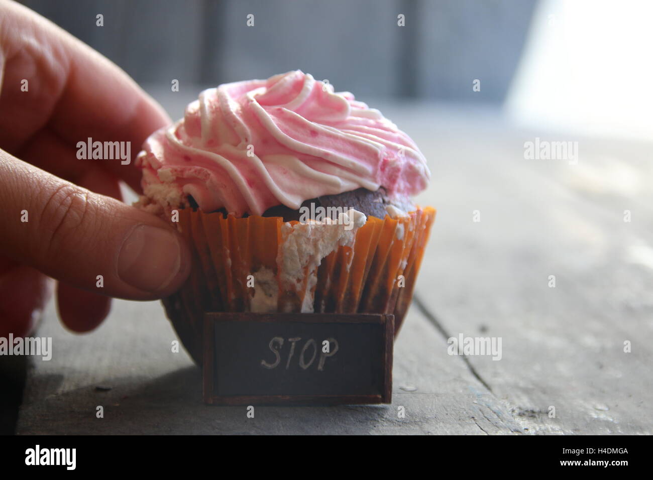 Cupcake, and text Stop - diet idea Stock Photo - Alamy