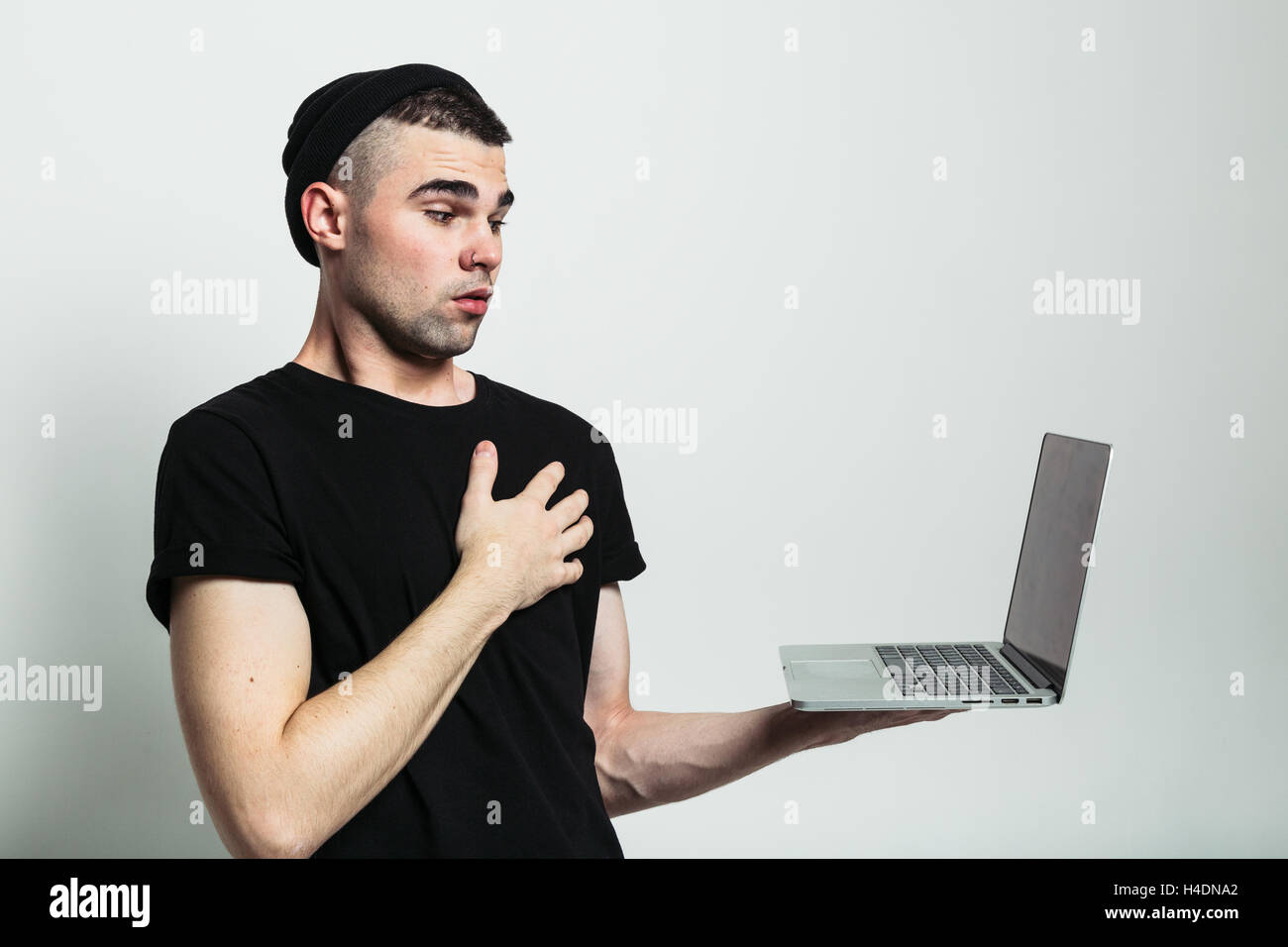 Shocked young guy holding hi-res stock photography and images - Alamy