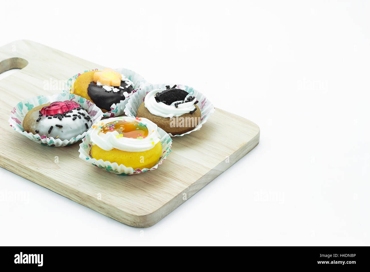 Mini multi-flavored cake on the wooden floor Stock Photo - Alamy