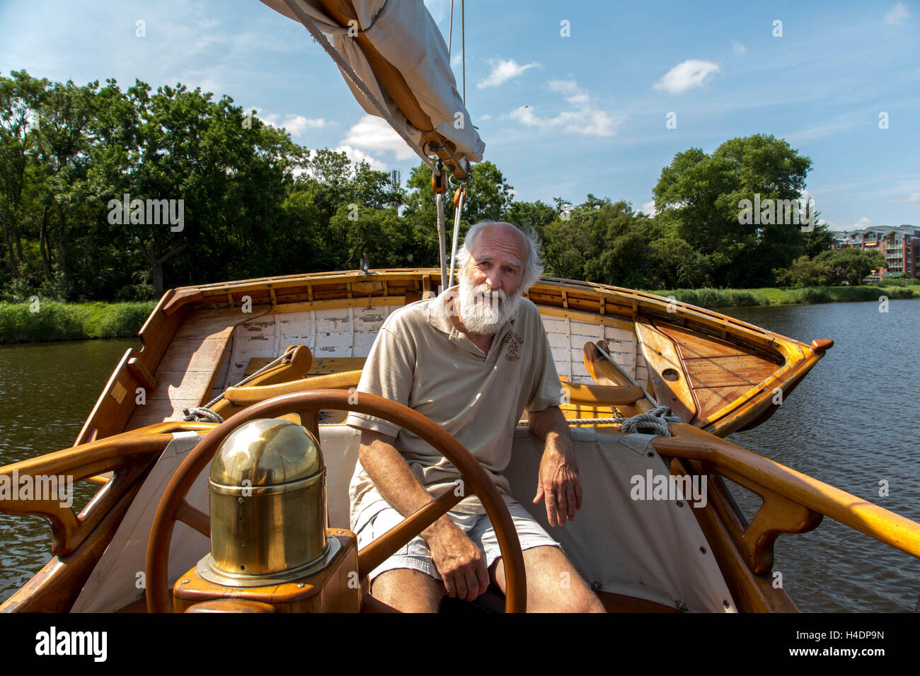 Older man on his sailing ship Stock Photo - Alamy