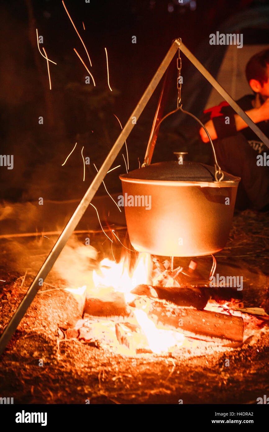 boiling pot over an open fire on a blurred background Stock Photo - Alamy